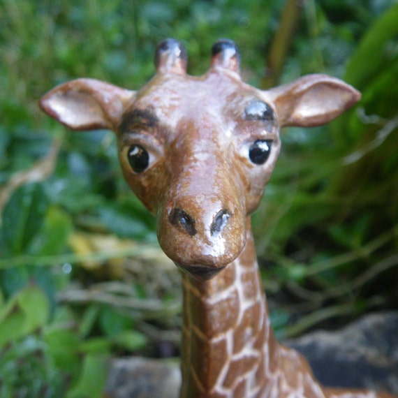 Giraffe ceramic figurine.