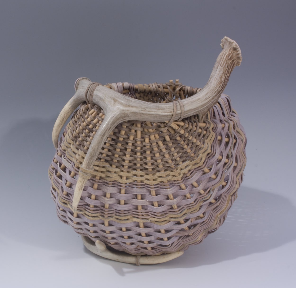 Antler Basket woven with pale blue reed features 2 antlers
