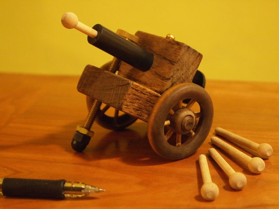Spring-loaded wooden toy cannon