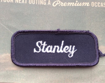 Zack. A yellow work shirt patch that says Zack in