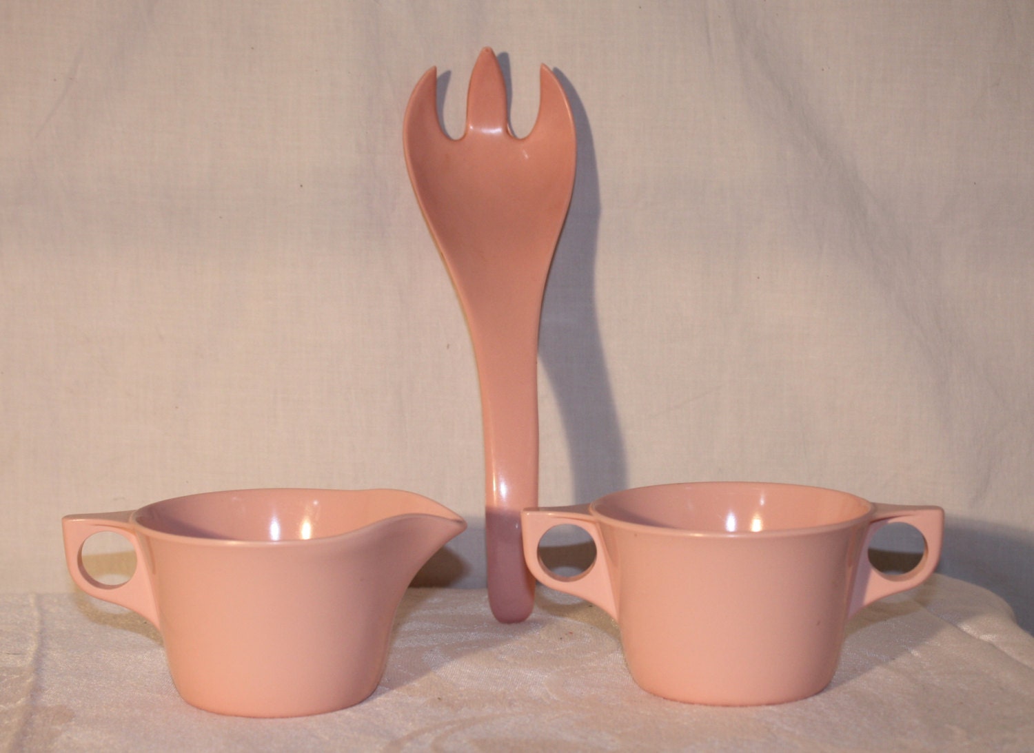 Pink melmac style sugar bowl, creamer, and a serving spoon fork, 3 pc ...