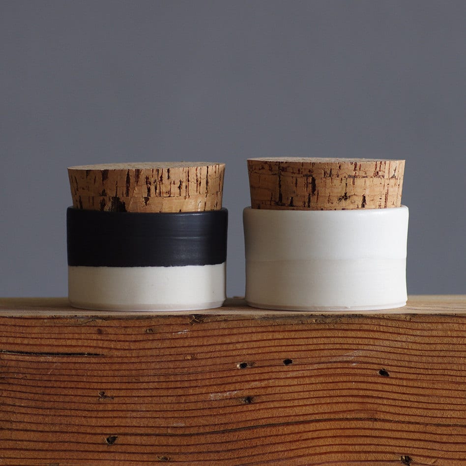 pair of corked cellars. salt and pepper cellar. black and white pottery ...