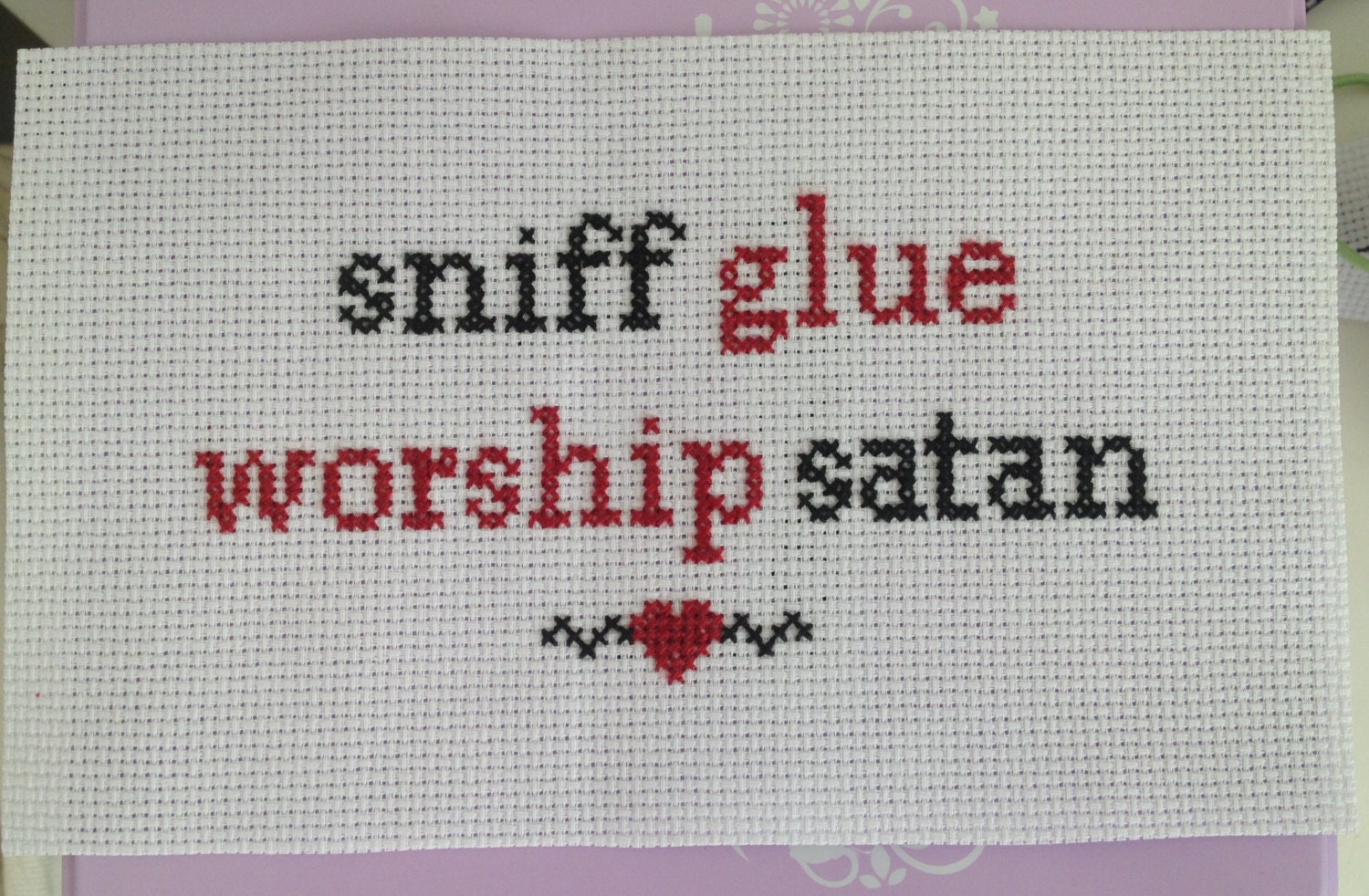 Items similar to Offensive cross stitch "Sniff Glue Worship Satan" on Etsy