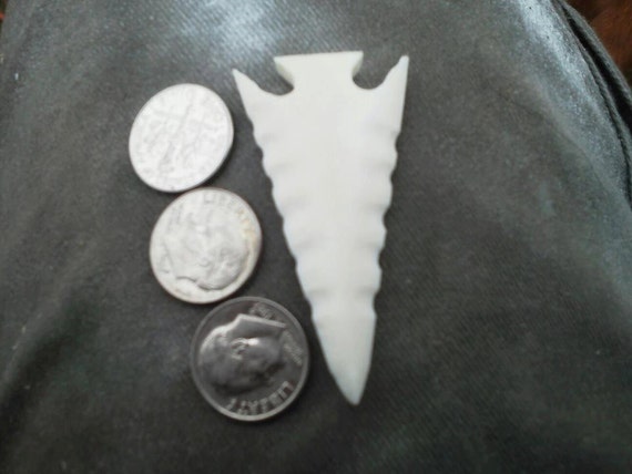 Items similar to Hand carved bone arrowhead pendant on Etsy