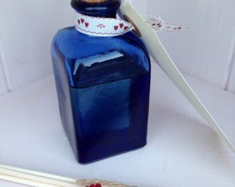 Essential oil reed diffuser in blue glass bottle
