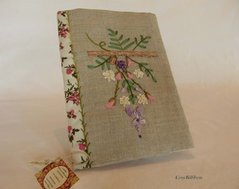 Linen paperback book cover, embroidered silk in a cosy design.