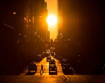 The setting sun is visible down the streets of Chicago during the ...