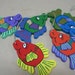 5 colorful wooden fish on a string.