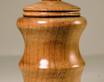 This hand crafted segmented wooden treen is made of