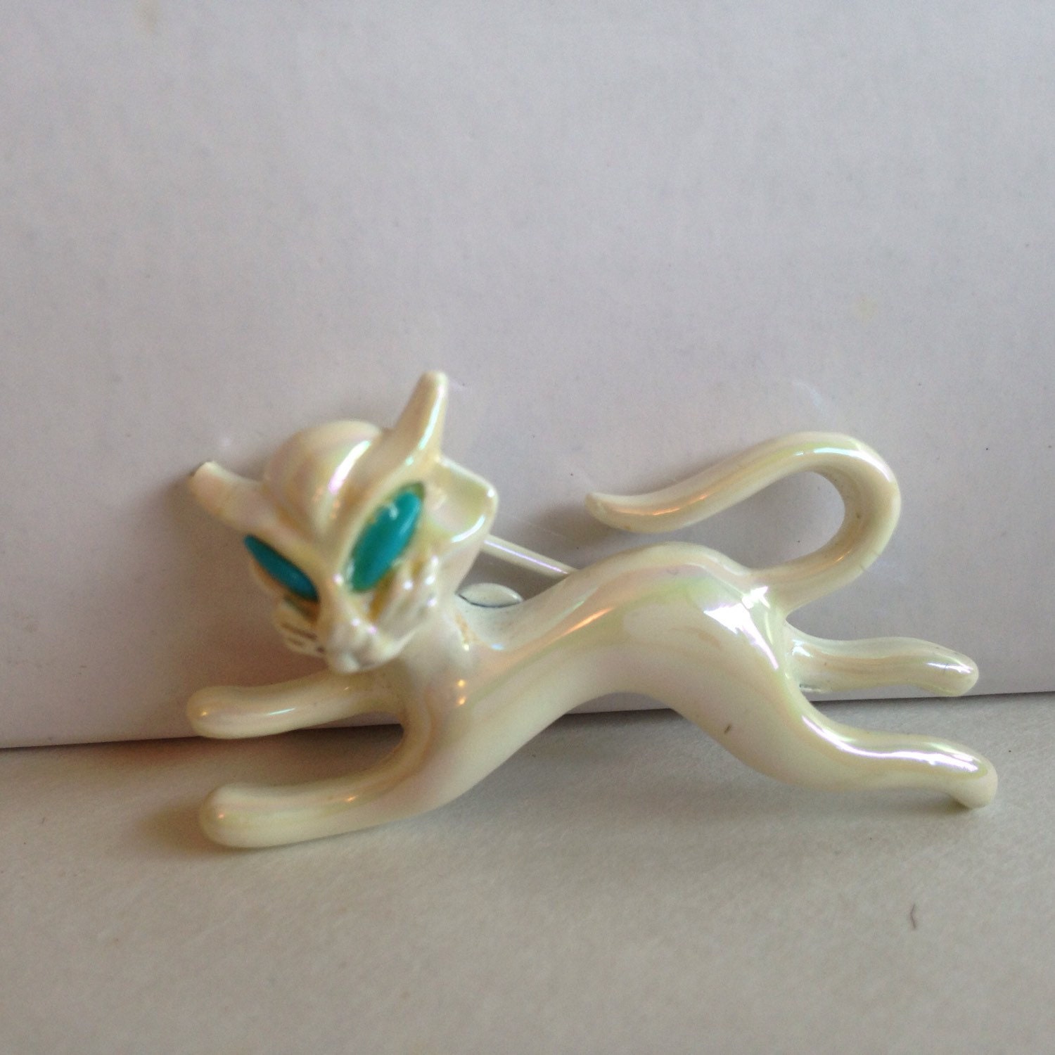 Iridescent white enamel cat brooch
