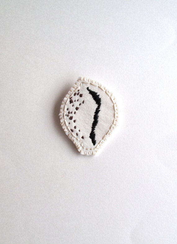 Cowrie shell brooch hand embroidered on cream muslin with