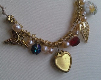 Charmed Bracelet with Gold tone Hummingbird & by TheGildedLilyuk
