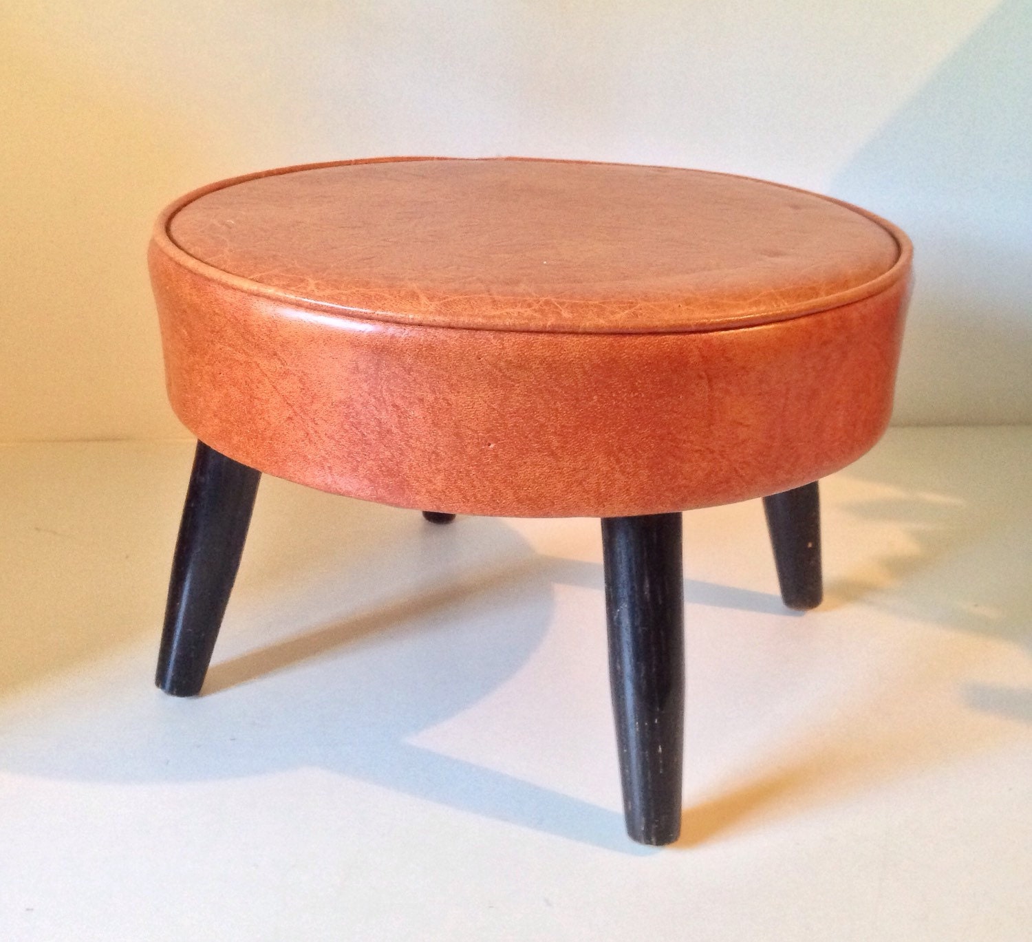 vintage ottoman MCM rust orange round vinyl footstool with