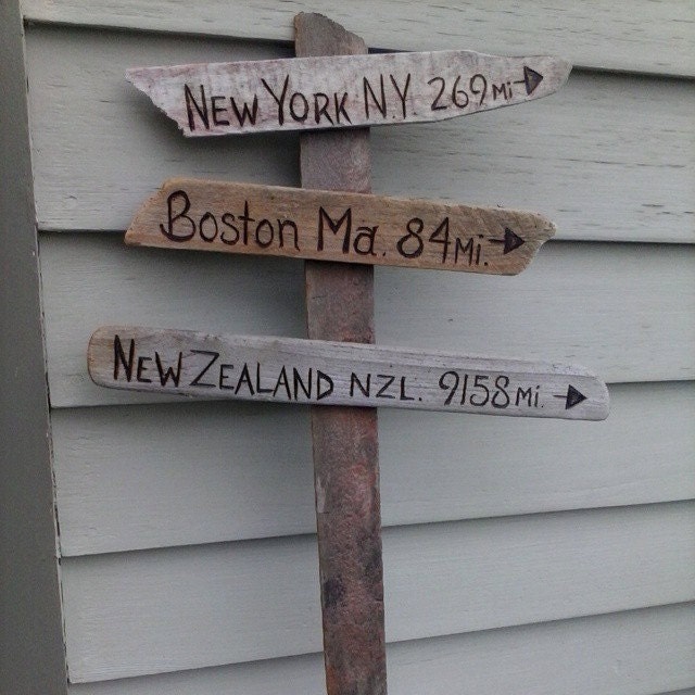 Distance FROM TO signs on driftwood road sign miles to go