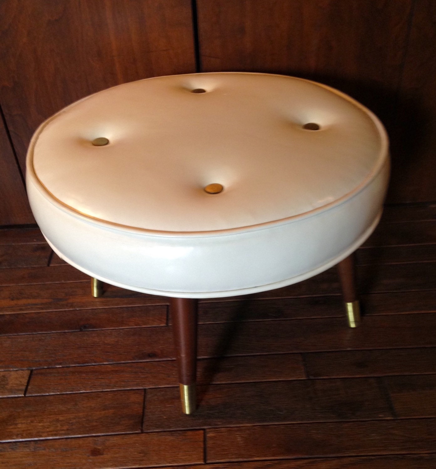 Large Round Cream Colored Vinyl Ottoman with Gold Button