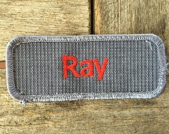 Zack. A yellow work shirt patch that says Zack in