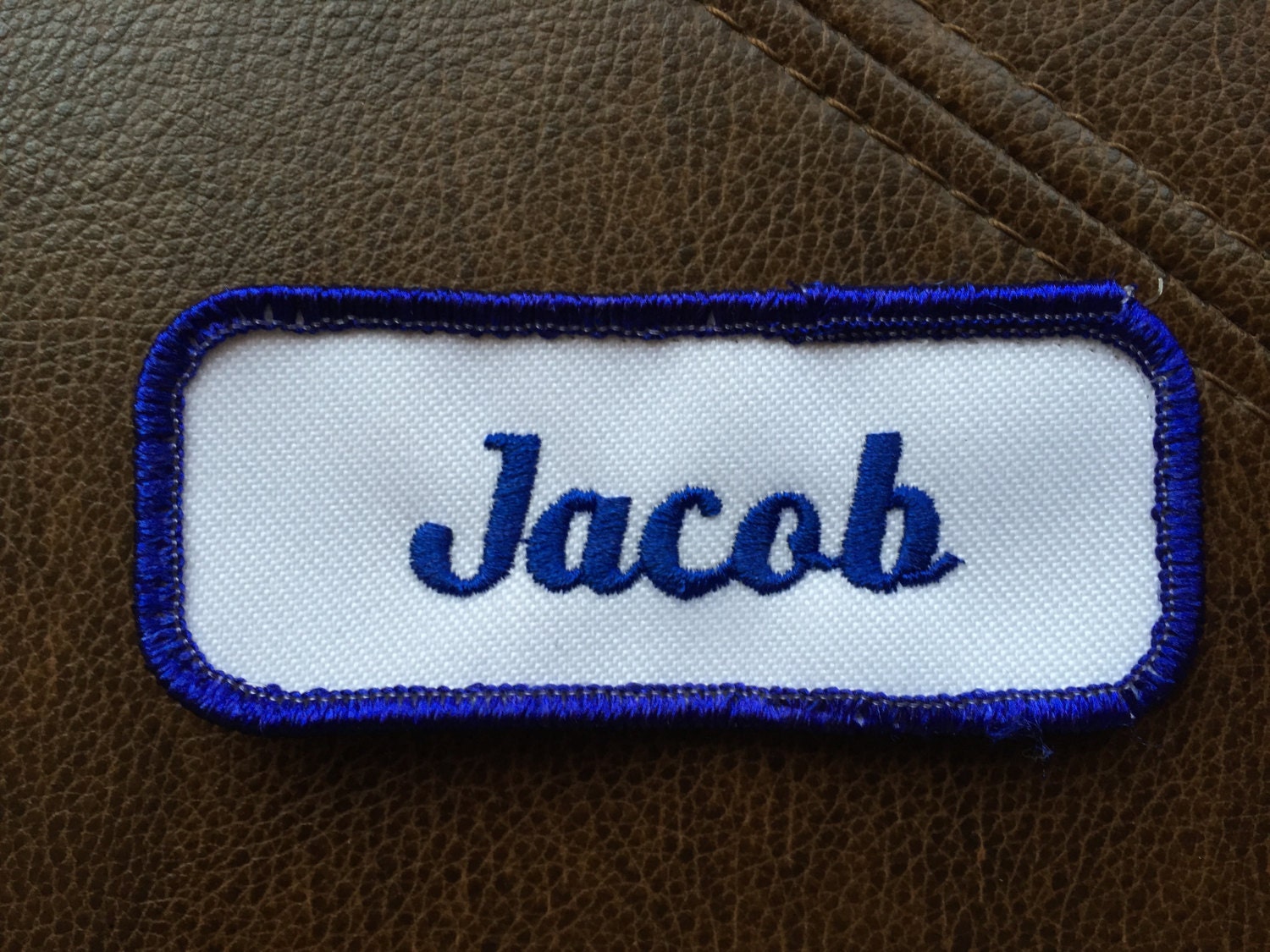 Jacob – LAST ONE! A work shirt name patch that says “Jacob” in blue ...