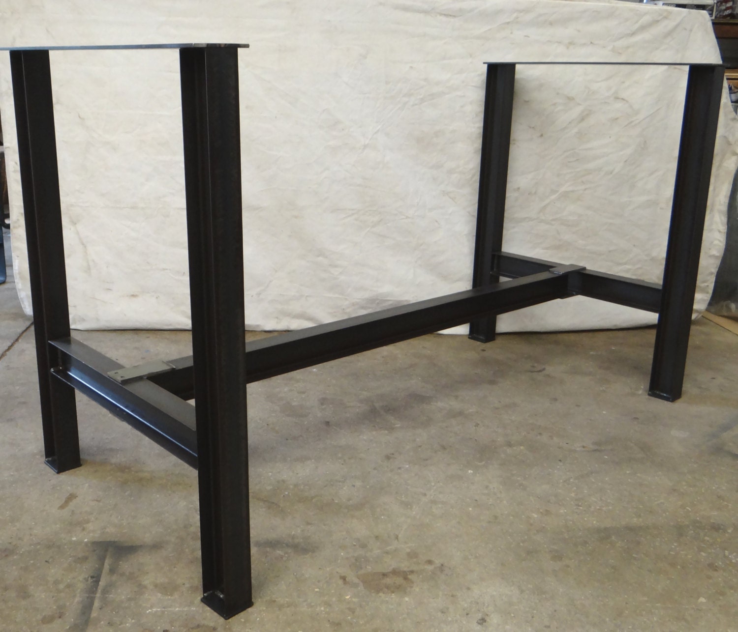 I-beam dining table base with metal span by TimberForgeWoodworks