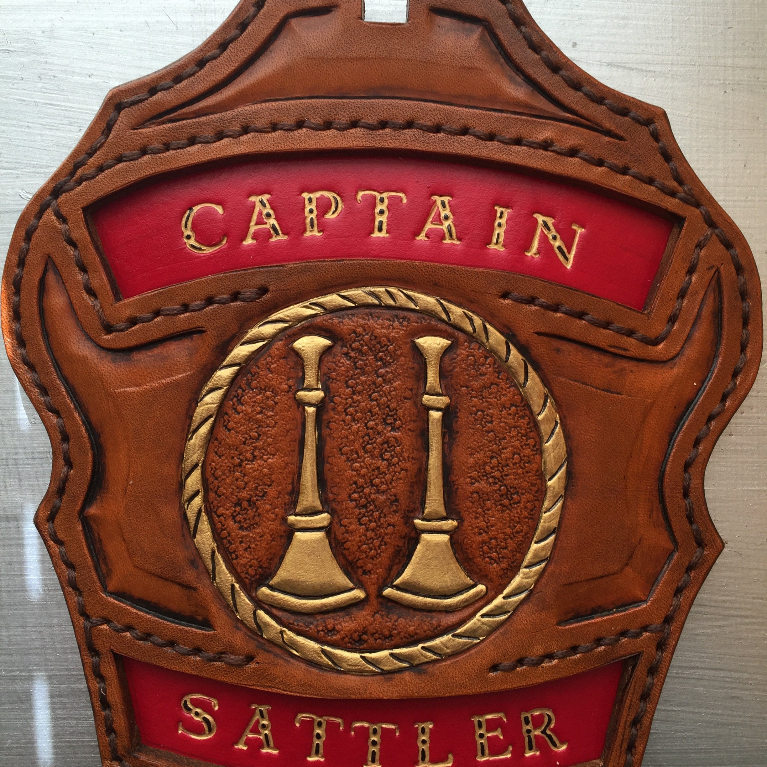 Custom leather firefighter helmet shields by LadderCompanyLeather