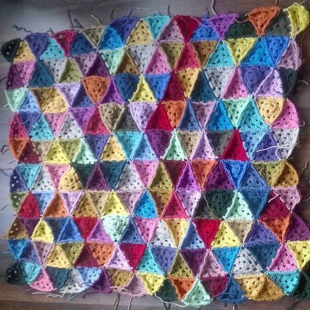 Crocheted granny triangle blanket