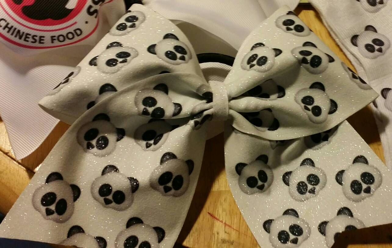 Panda emojis cheer bow on white ribbon or white glitter
