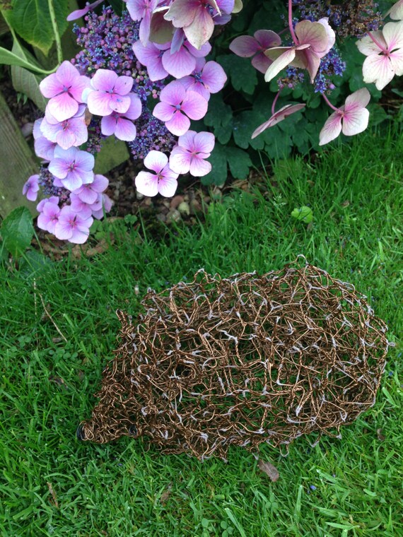 Hedgehog wire sculpture. Metal garden sculpture. Garden.