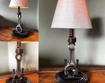 Hand crafted table lamp using repurposed engine/car parts.
