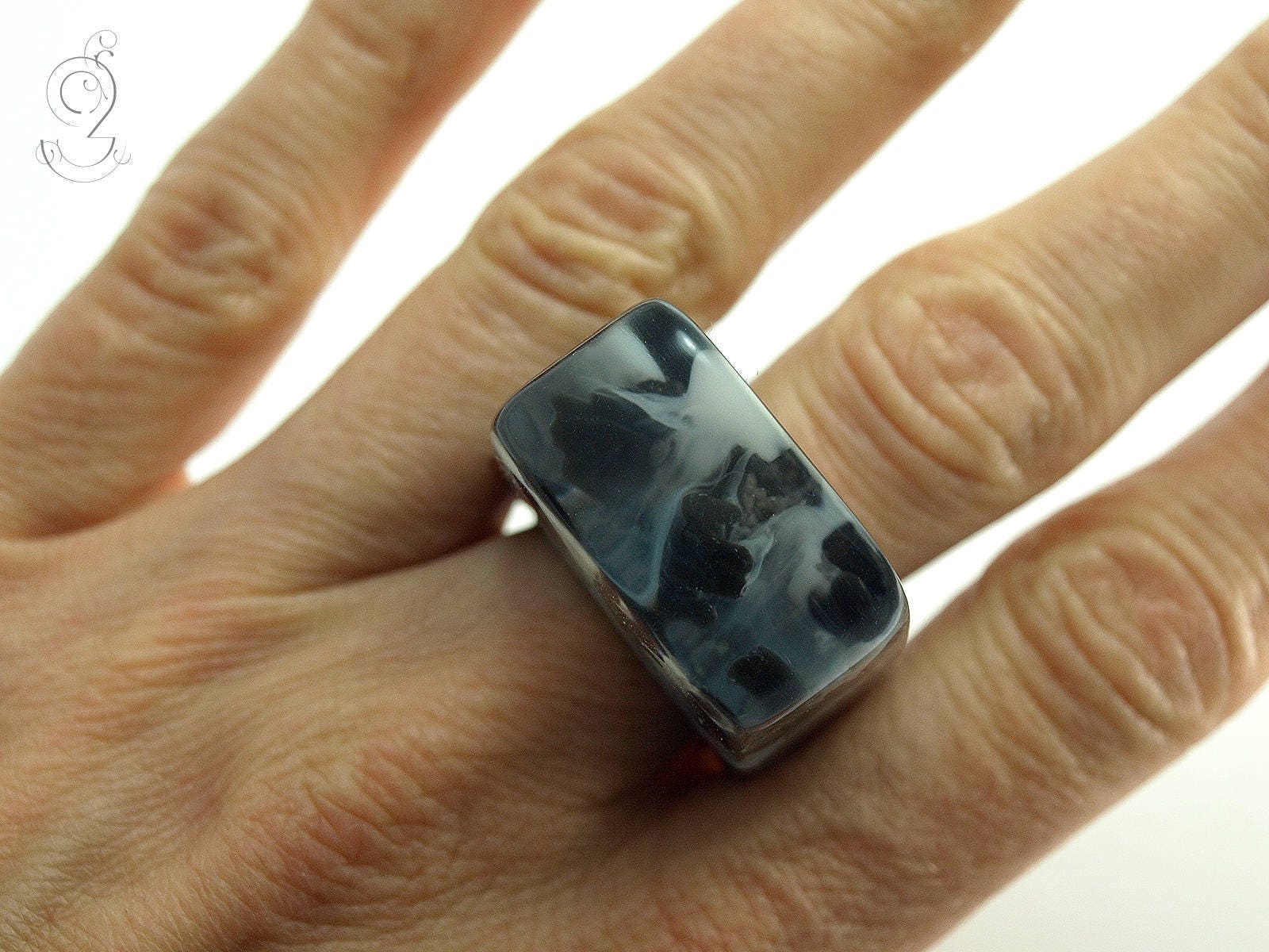 Zombie creepy undead ring with three black hands and fog on
