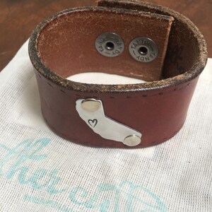 handstamped leather cuffs by mothercuffer on Etsy