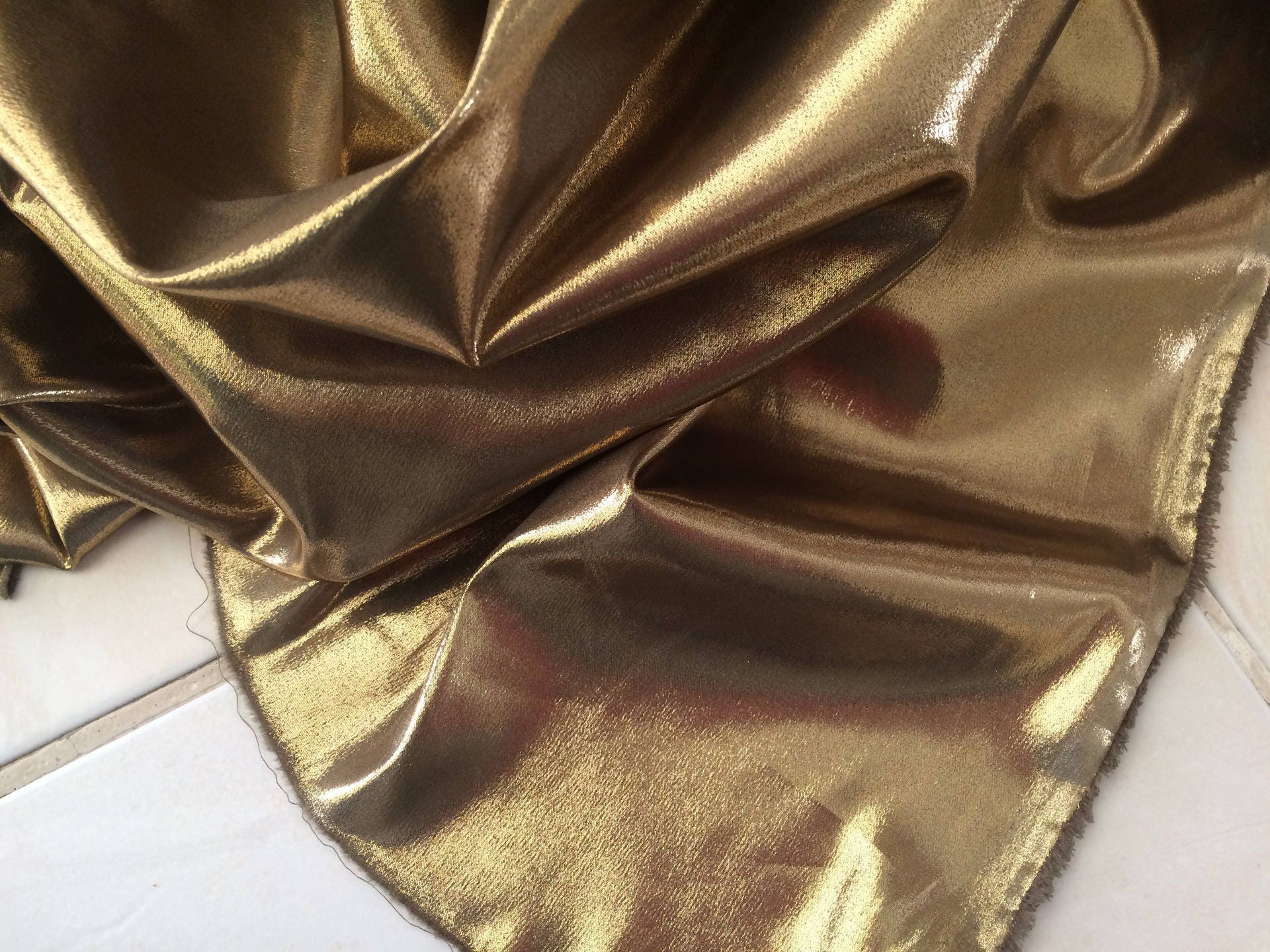 Fabrics in festive gold satin color metallic very soft and