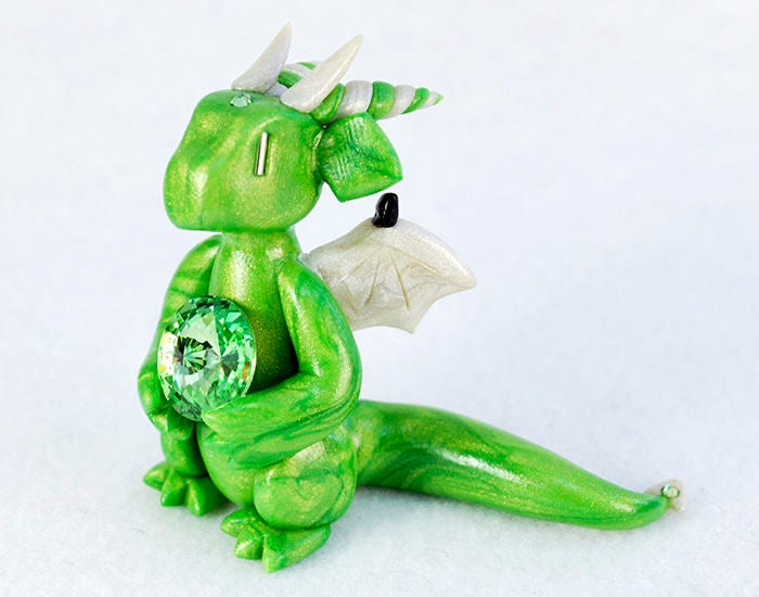 August birthstone dragon with peridot gem light green dragon