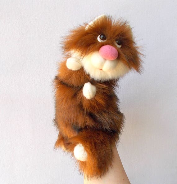 Puss actor. Red and fluffy. Bibabo. Toy on hand. Marionette.